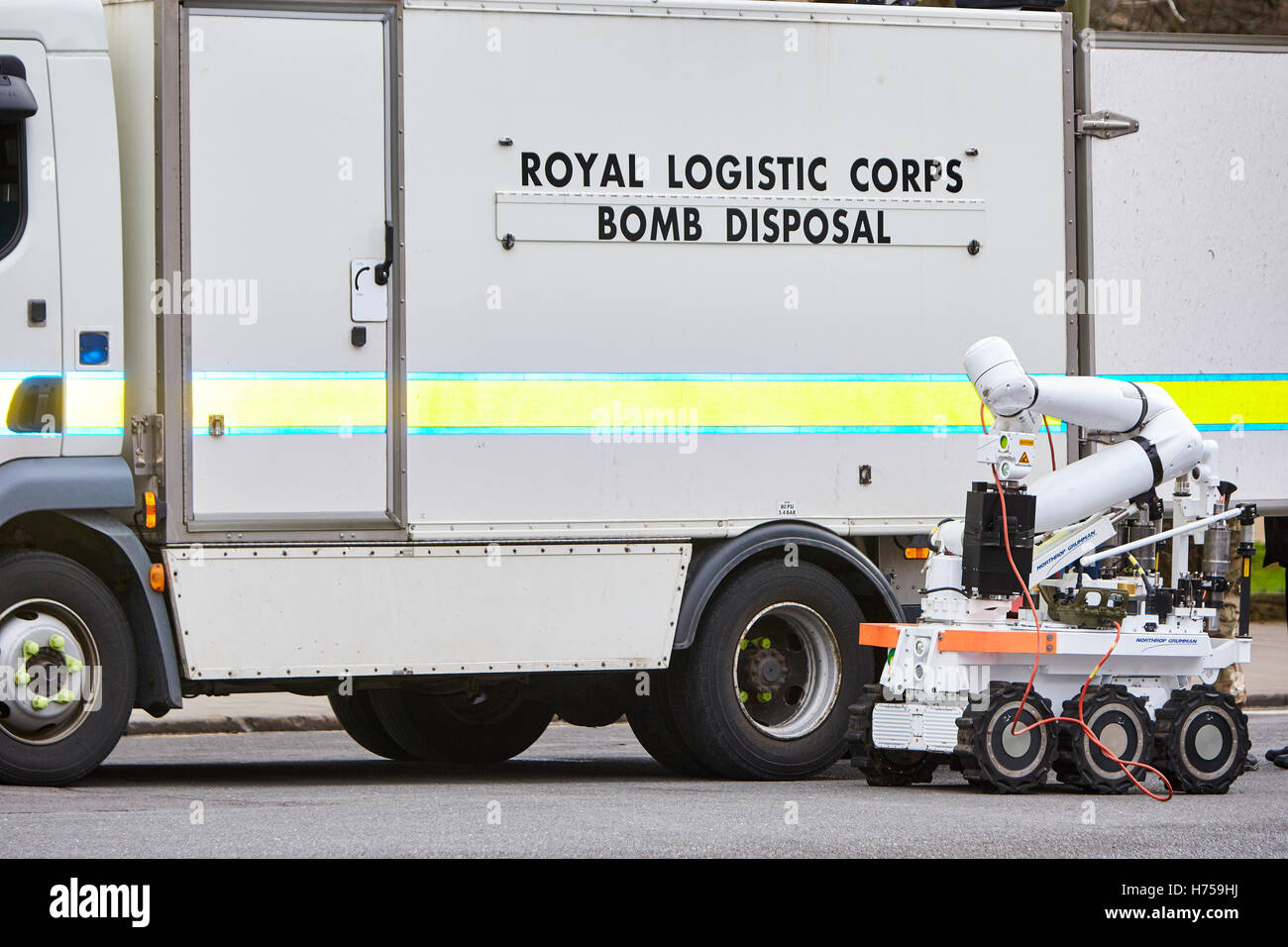 Bomb disposal officers prepare a remote robot to deal with a bomb at an ...