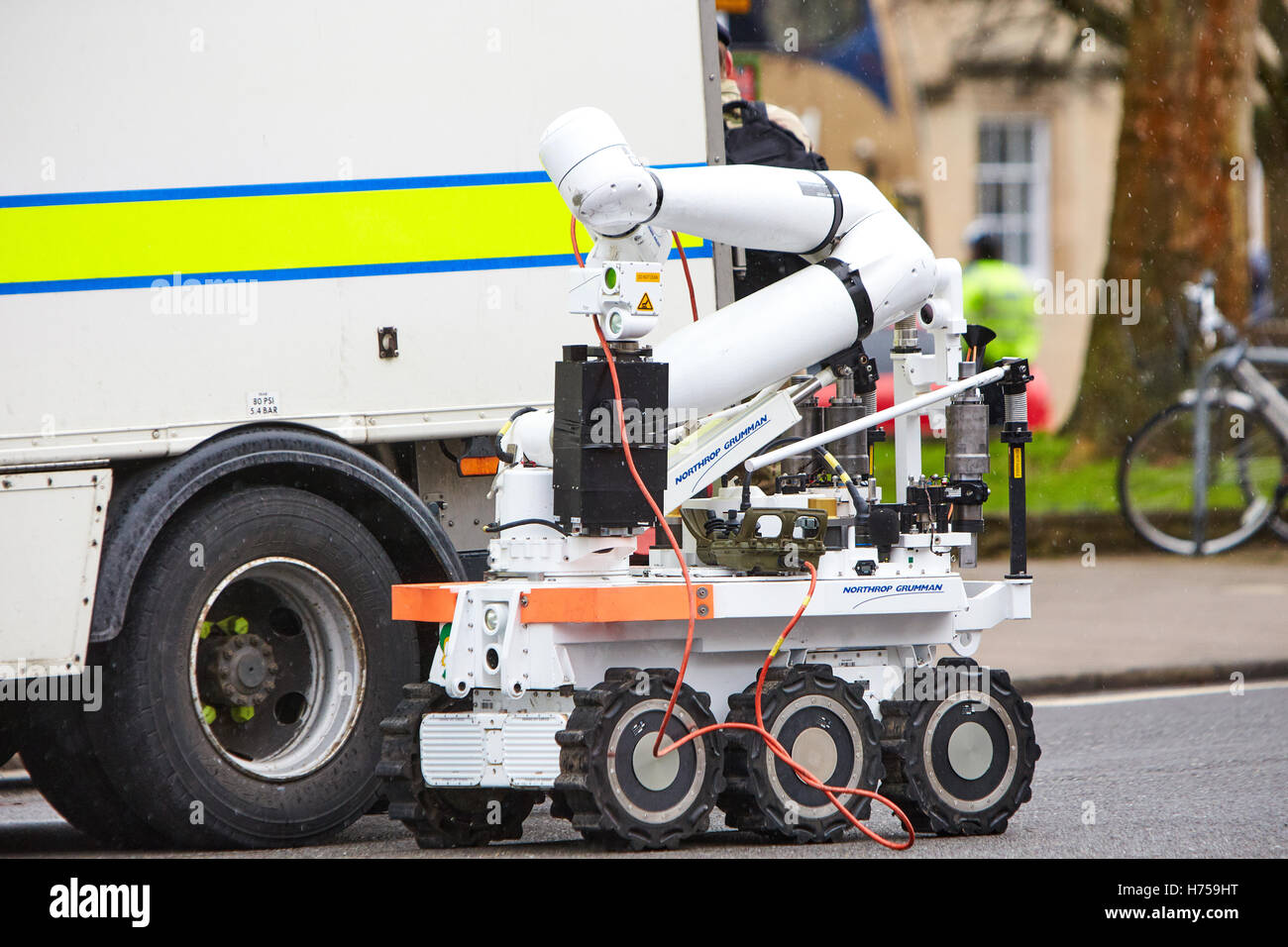 Bomb disposal officers prepare a remote robot to deal with a bomb at an ...