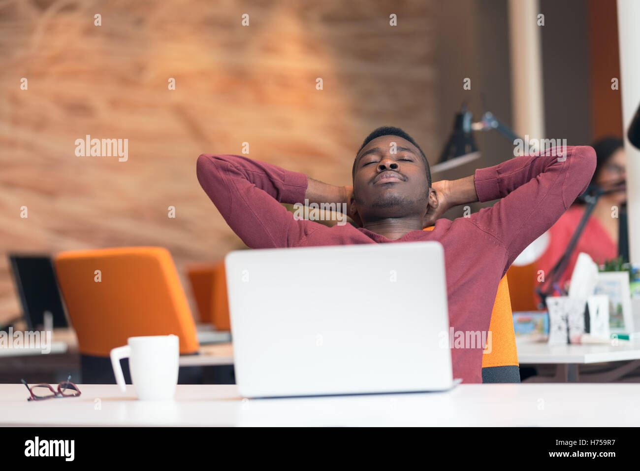 Young African-American business man taking a break at his desk Stock ...