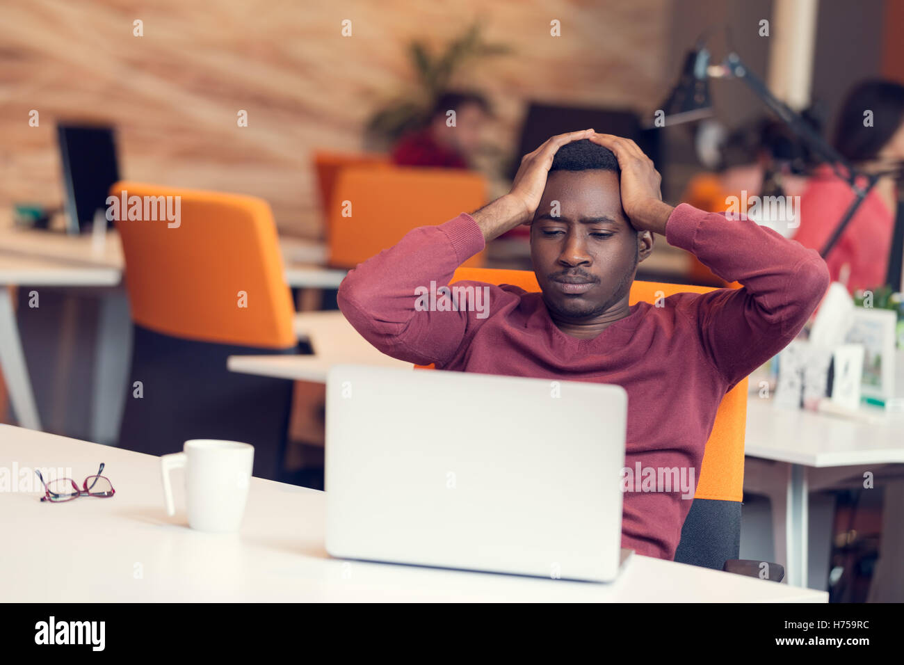Exhausted entrepreneur working with a computer in his office Stock ...