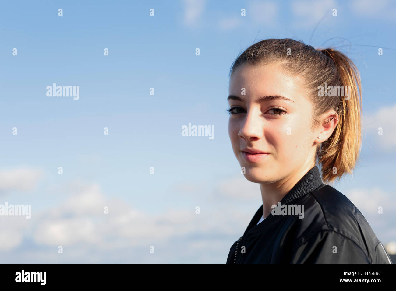 Teenager on the roof of a building. Natural daylight, horizontal shoot ...