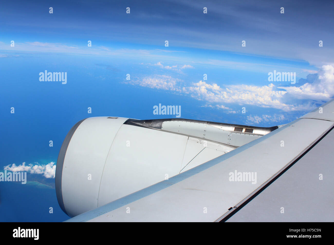 View from an airplane's window with the part of airplane and cloudscape ...