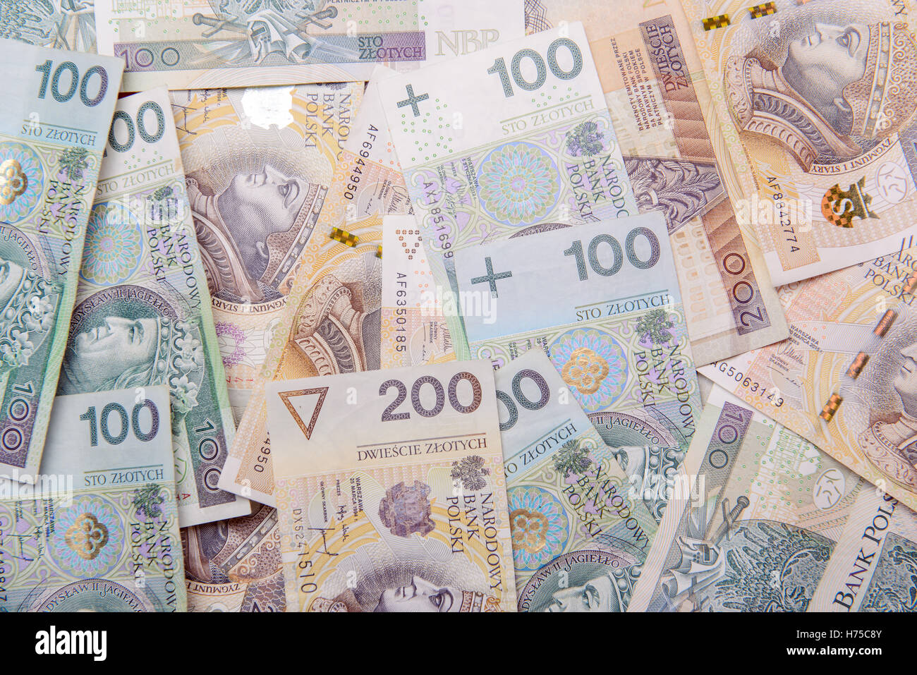 Polish zloty in notes and coins on red background Stock Photo - Alamy