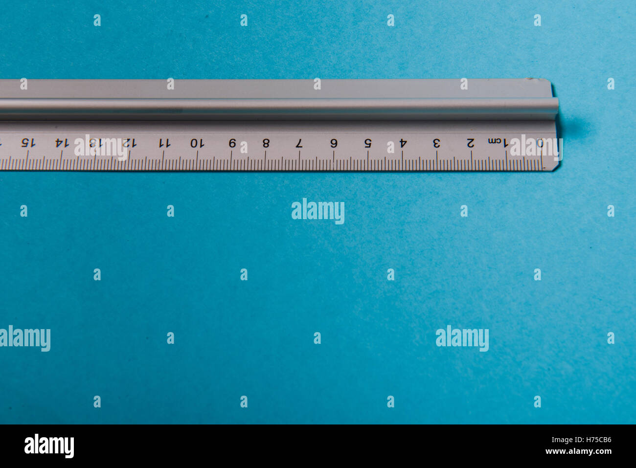 aluminum ruler on blue background. High resolution Stock Photo - Alamy