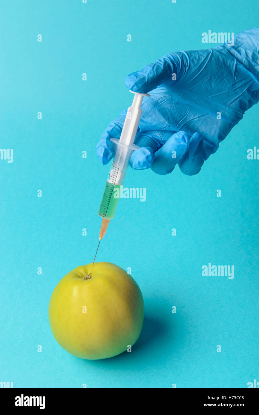 Chemical additives in food or genetically modified fruit concept. Green ...