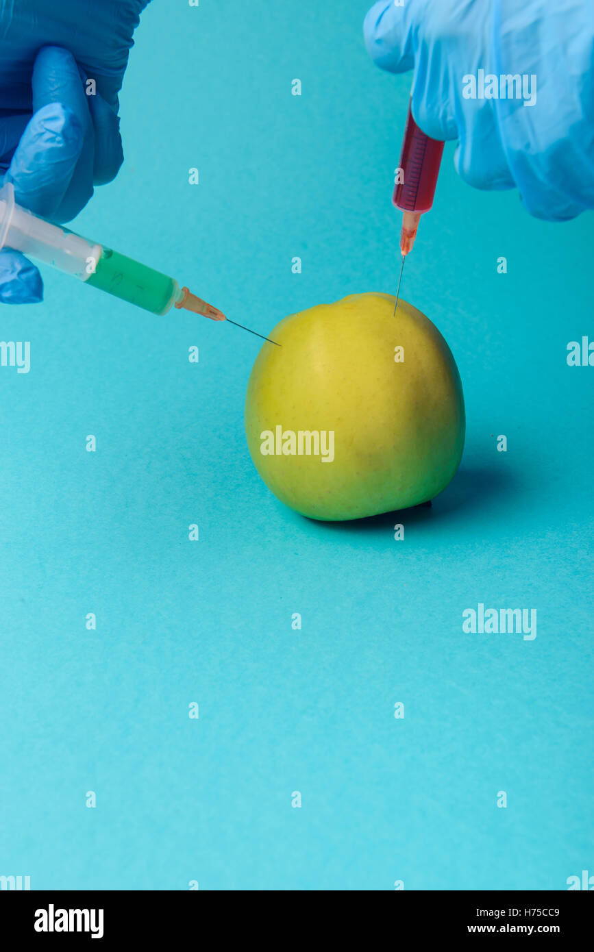 Chemical additives in food or genetically modified fruit concept. Green ...