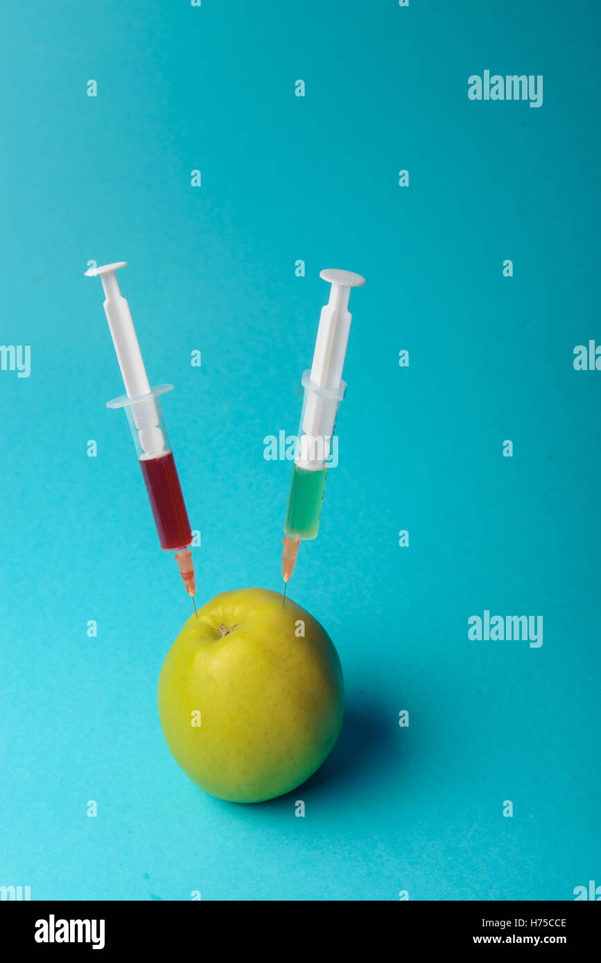 Chemical additives in food or genetically modified fruit concept. Green ...