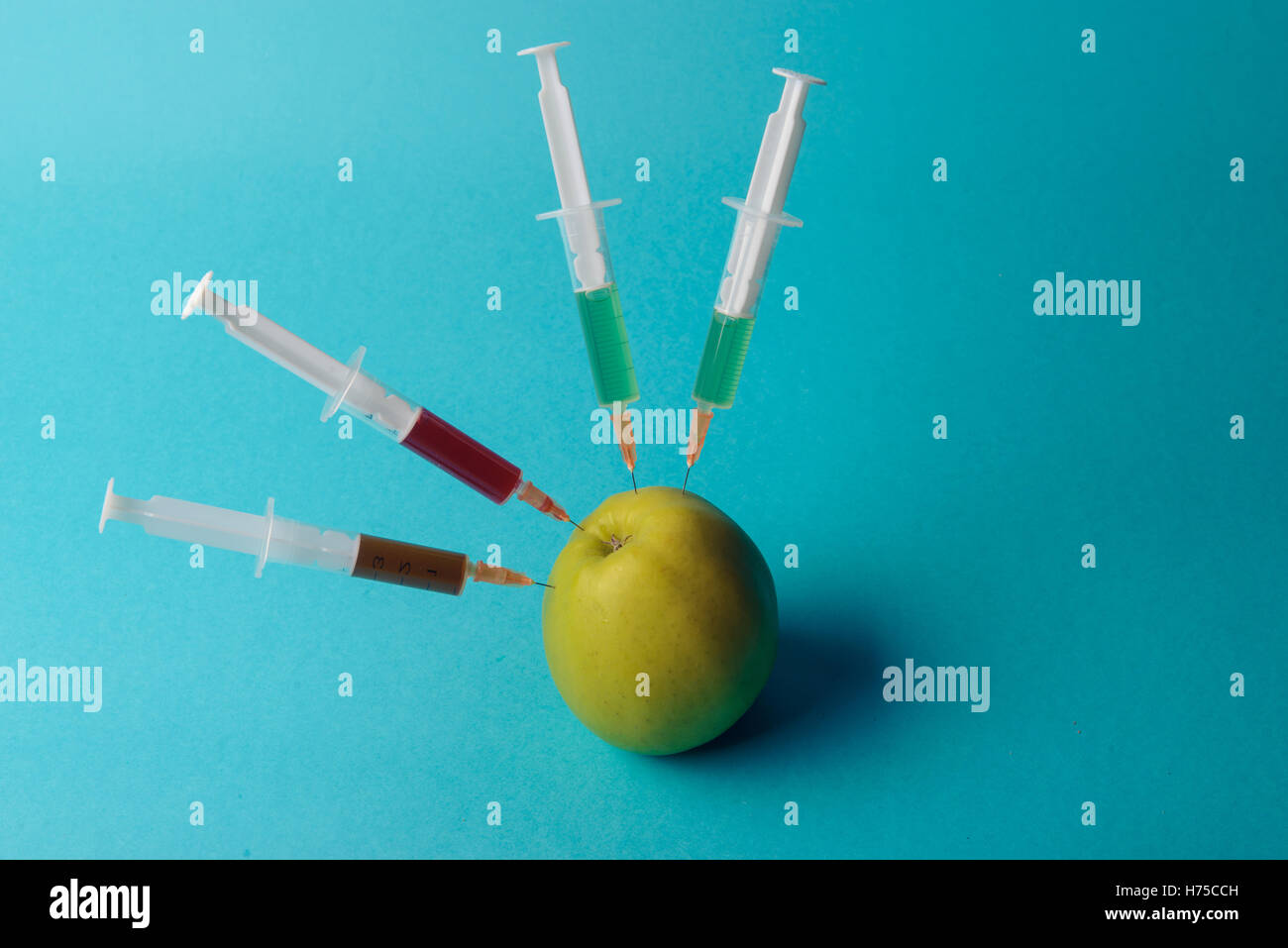 Chemical additives in food or genetically modified fruit concept. Green ...