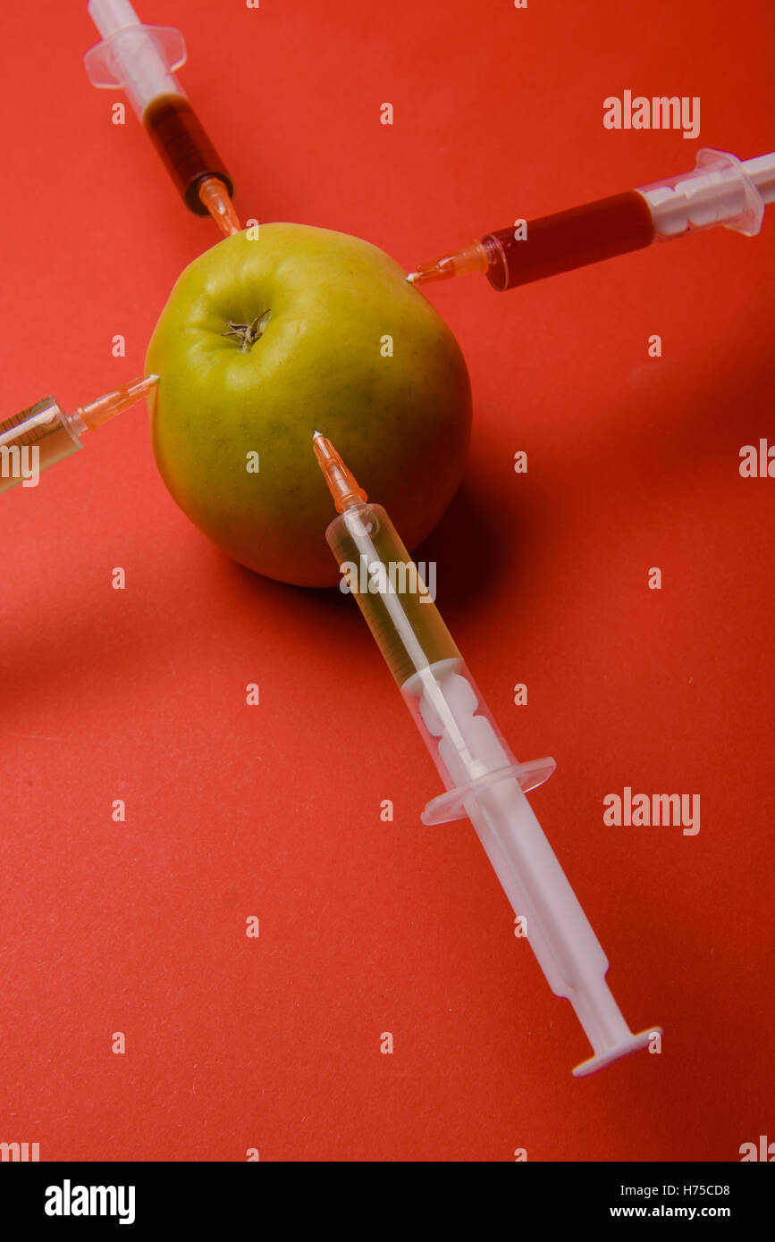 Chemical additives in food or genetically modified fruit concept. Green ...