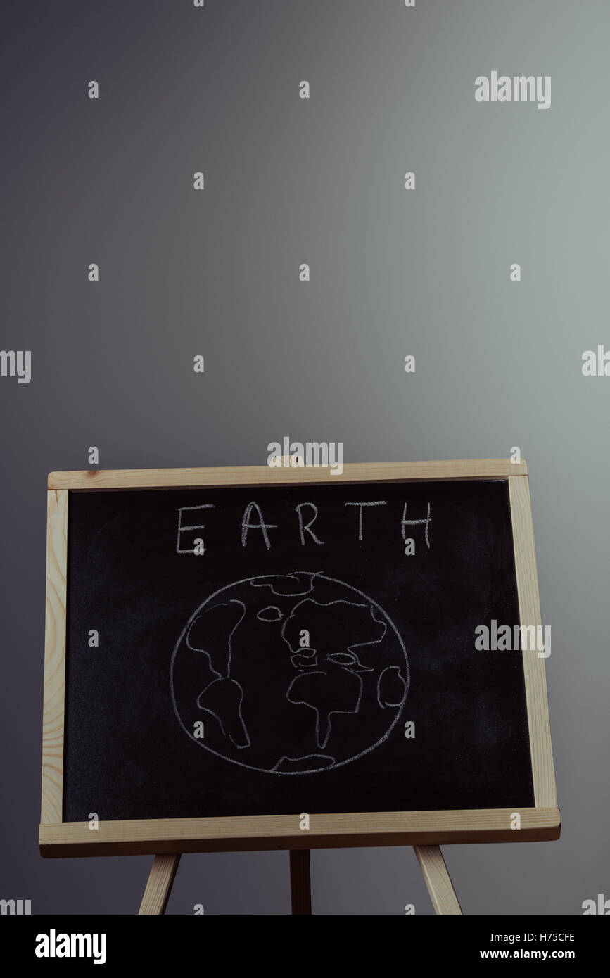 earth written on blackboard with earth symbol, background, high ...
