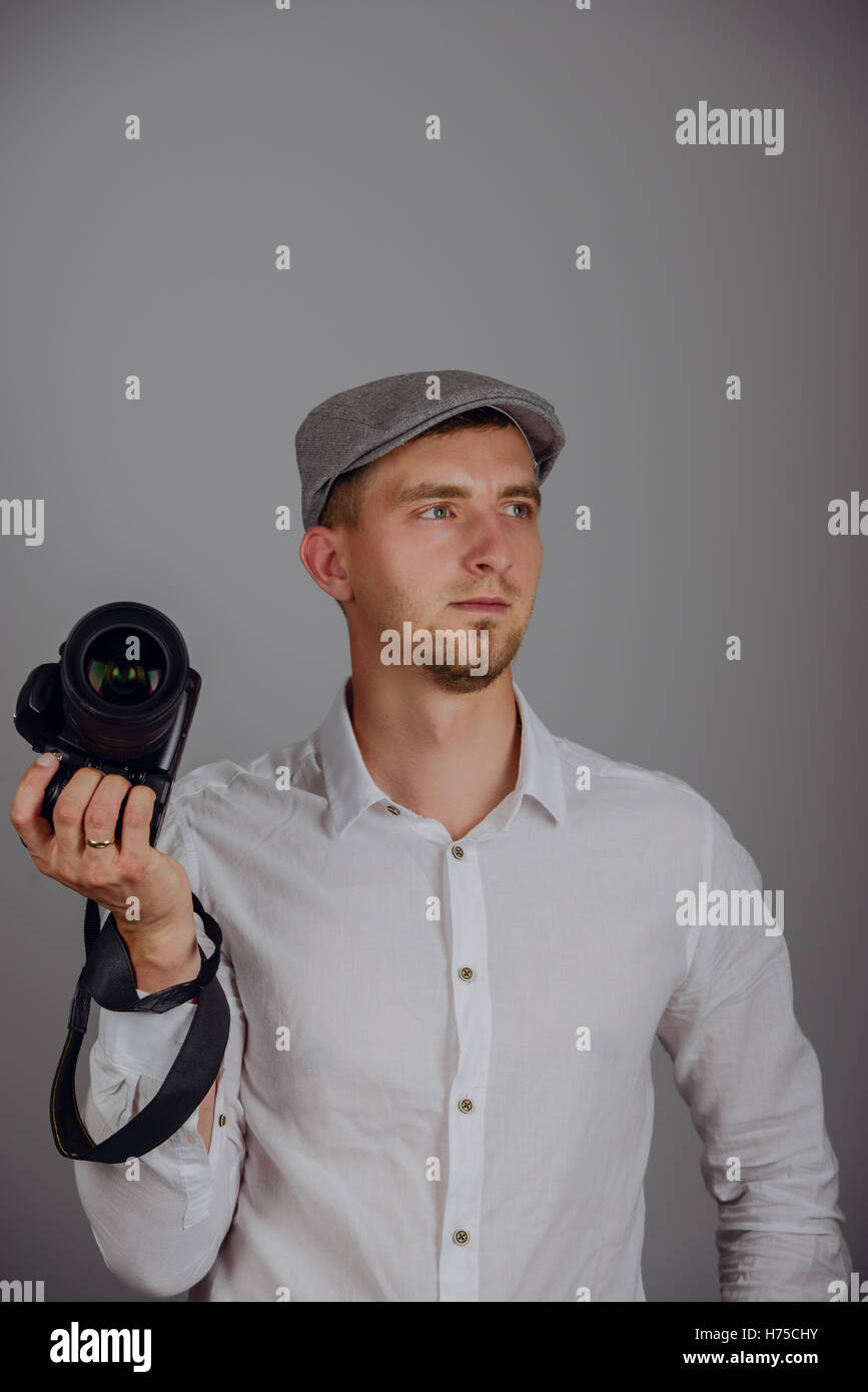 Young man using a professional camera in studio Stock Photo - Alamy