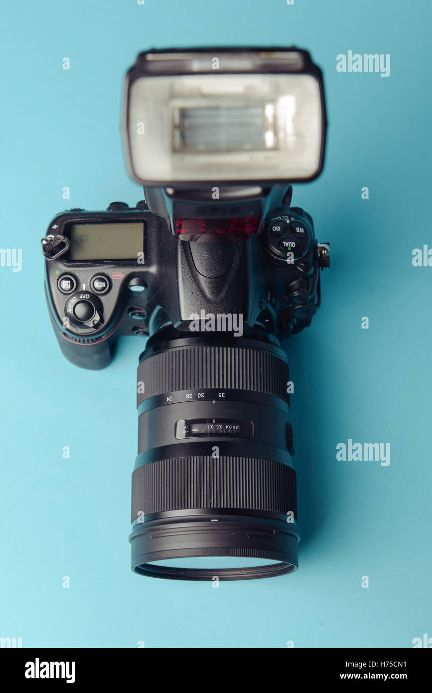Professional modern DSLR camera against blue background Stock Photo - Alamy
