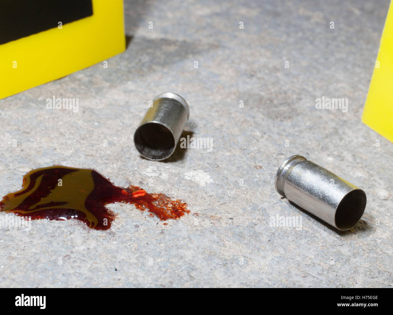 Handgun casings and blood on concrete with crime scene markers Stock ...