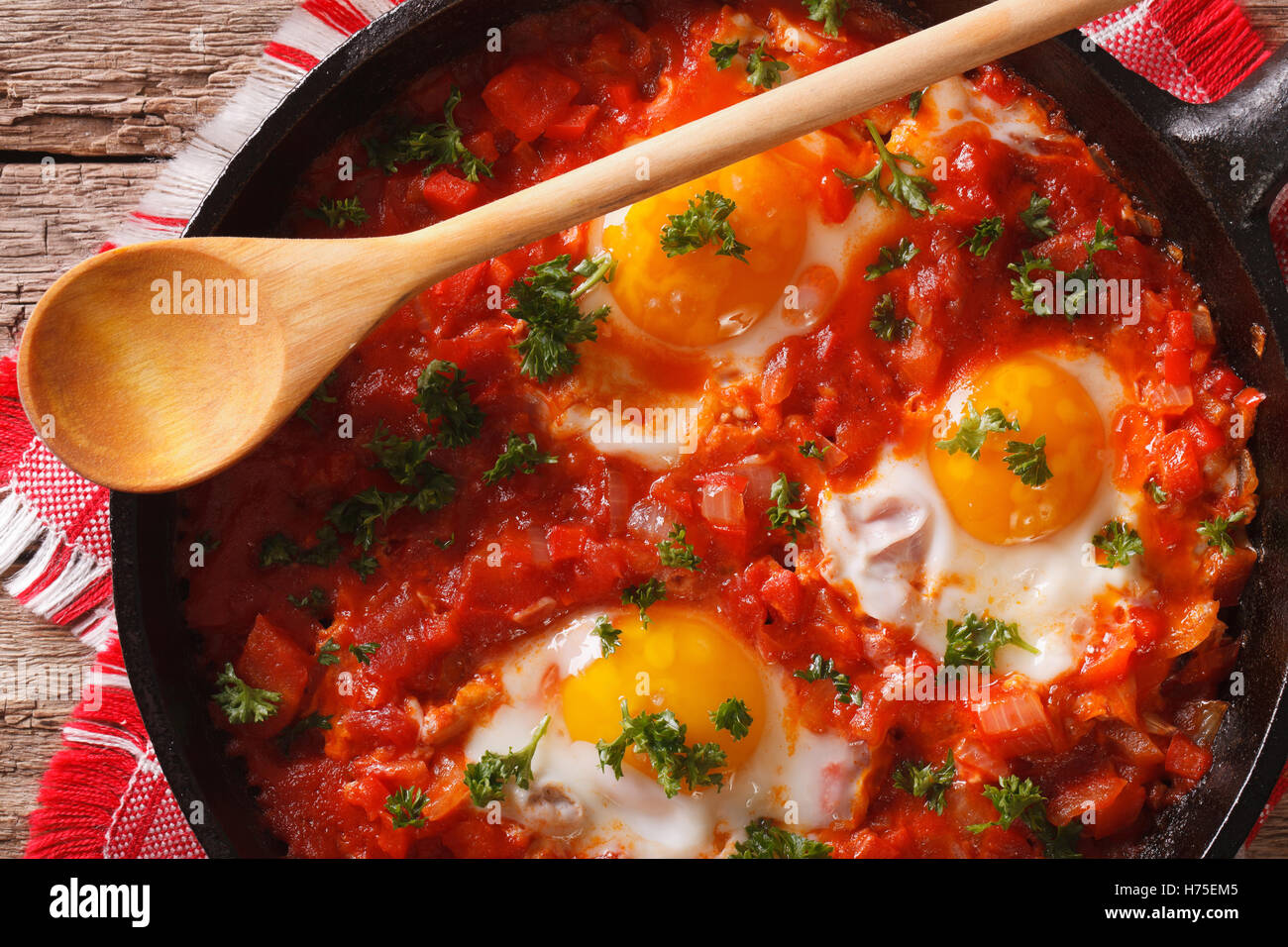 Shakshuka fried eggs macro in a frying pan. horizontal view from above ...