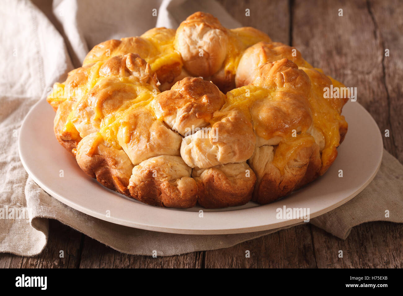 Delicious monkey bread with cheese close-up on a plate on the table ...