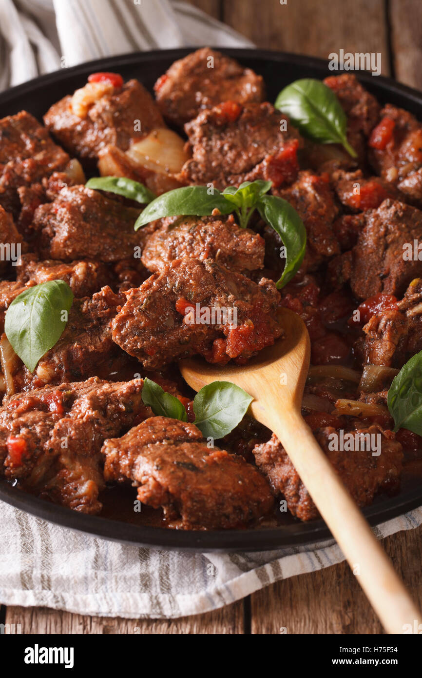 Greek cuisine: stifado beef close-up on the plate. vertical background ...