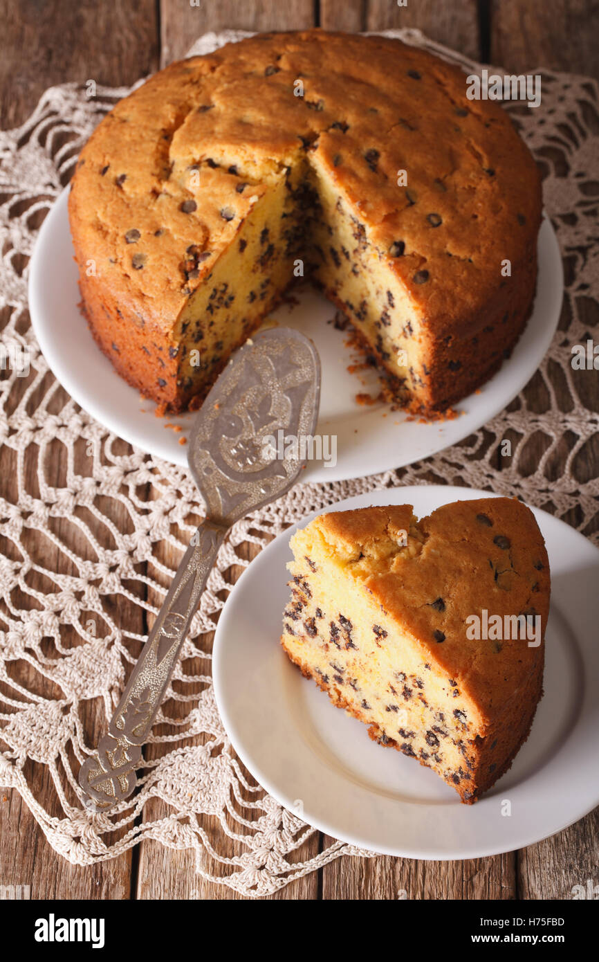 chopped sponge cake with chocolate Drops close-up on a plate. vertical ...