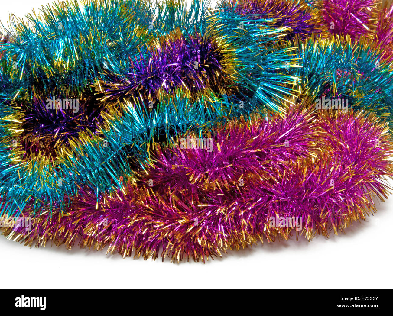 Colorful tinsel on a white background Stock Photo - Alamy