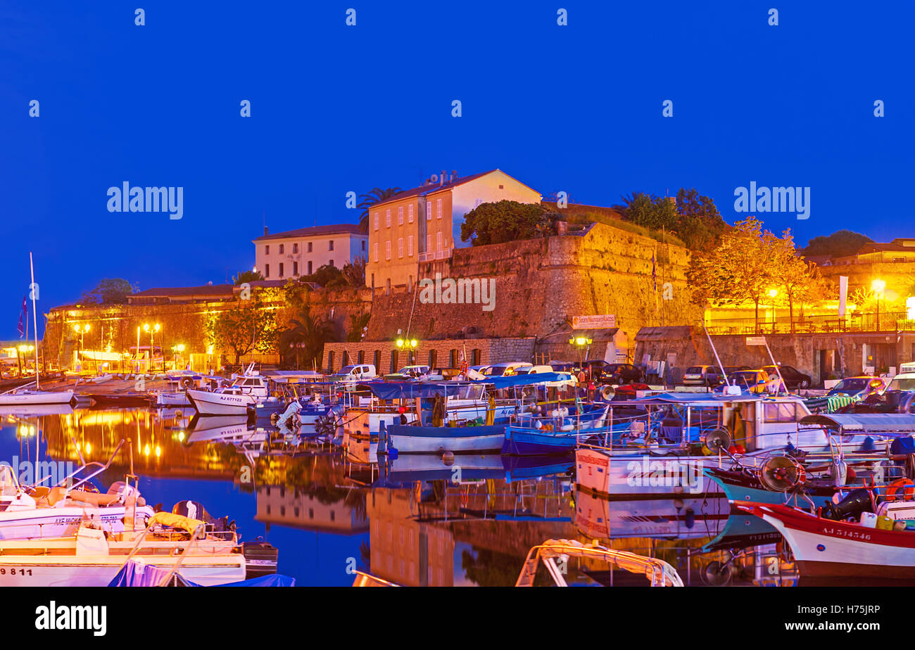 The colorful fishing boats in the old port and the brightly illuminated ...
