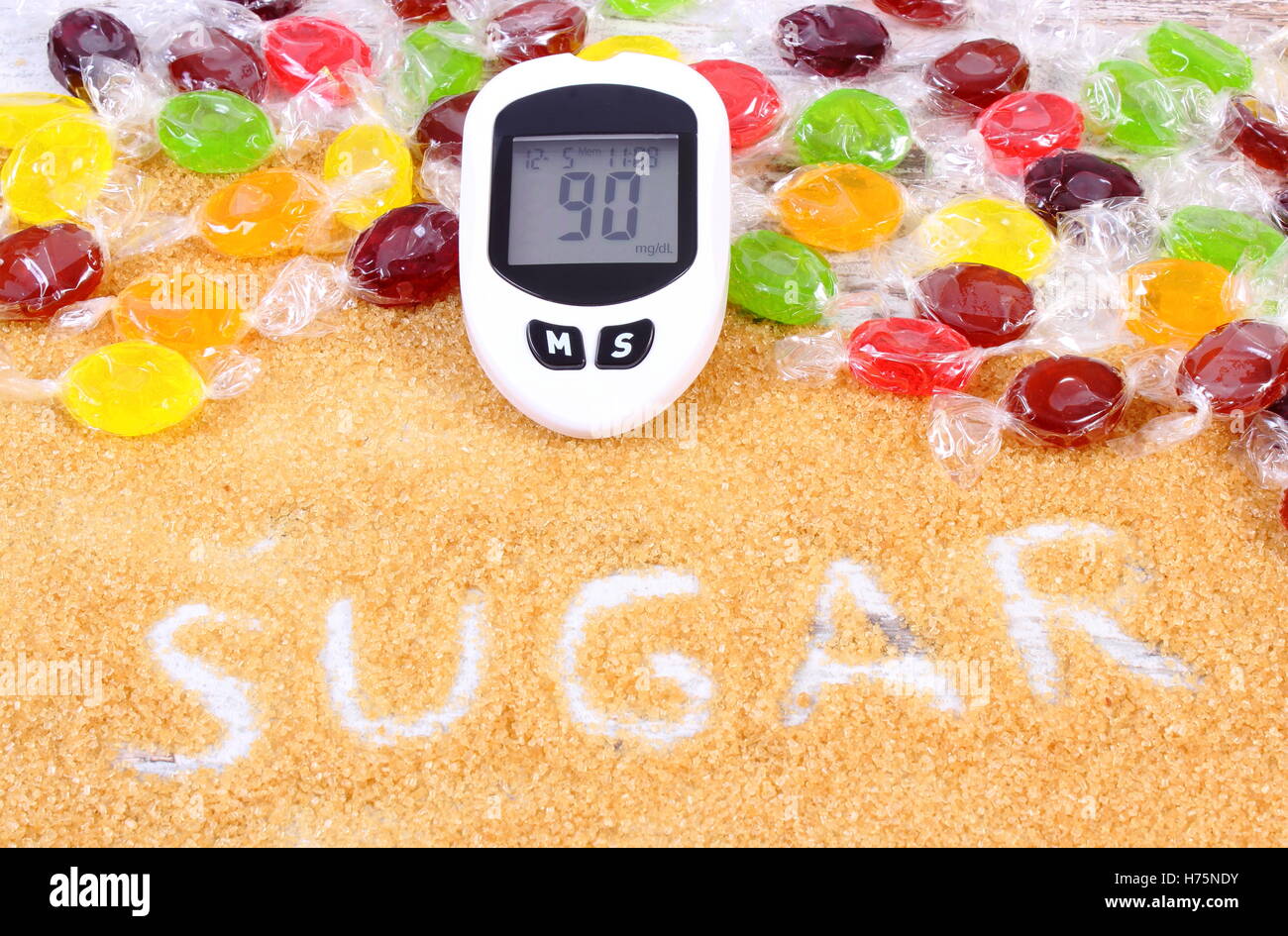 Glucometer with result of measurement sugar level, heap of colorful ...