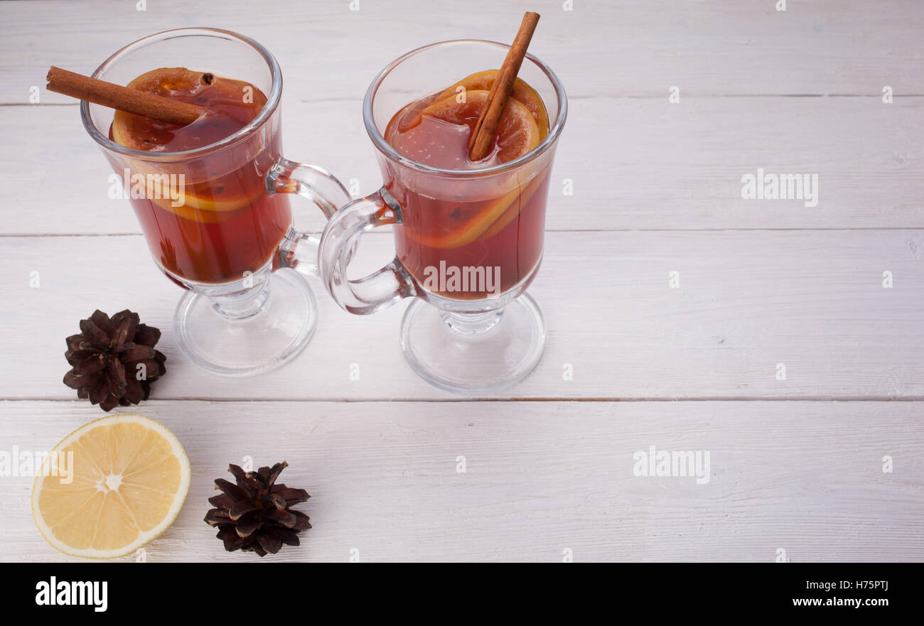 Two glasses of red hot drink on white table. Mulled wine Stock Photo ...