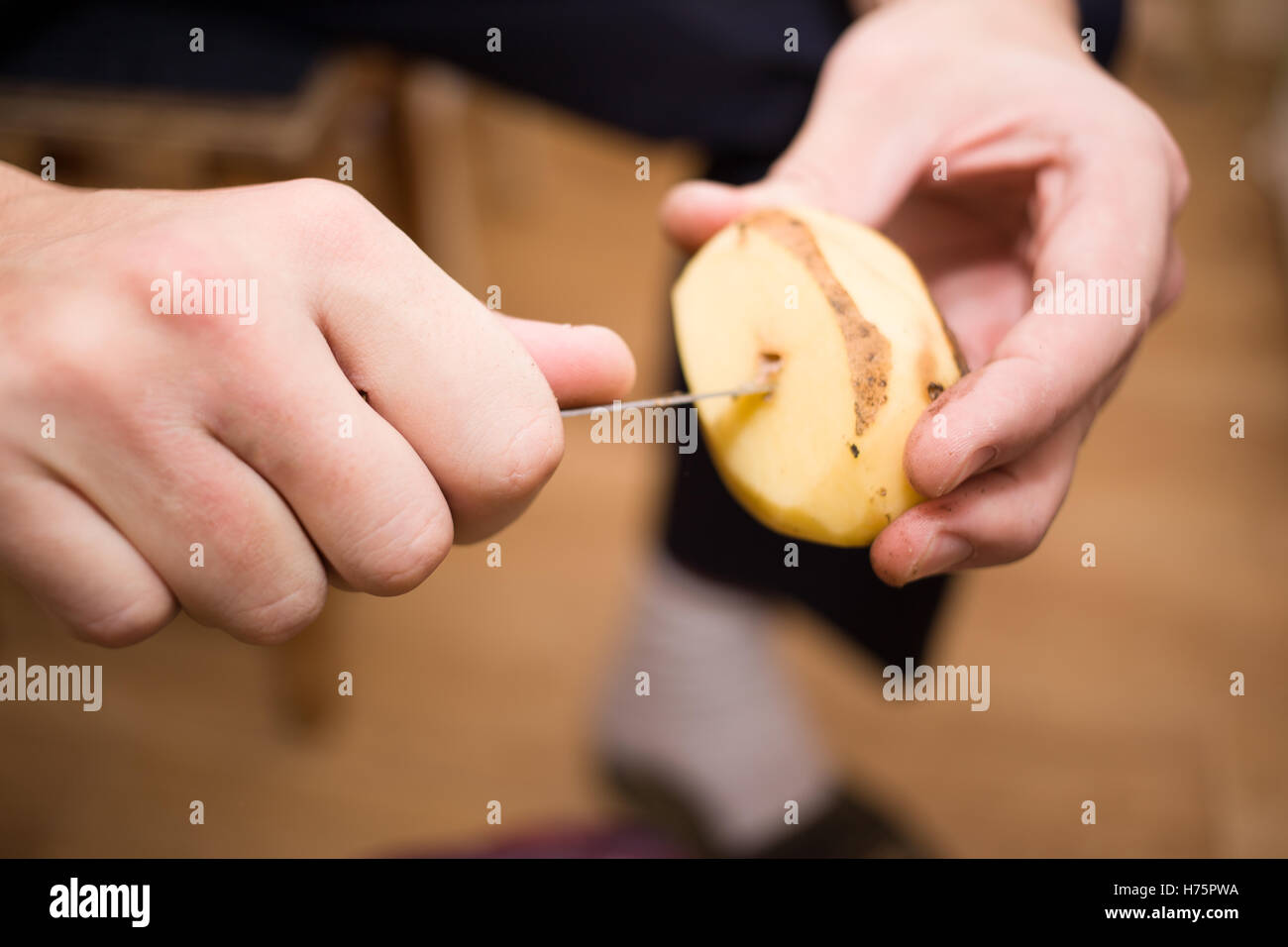 Mens Hands peeling potatoes in kitchen, closeup Stock Photo - Alamy