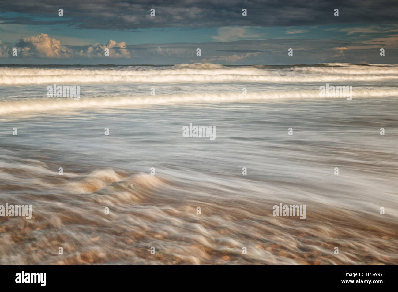 Long exposure capturing wave movement on a beach Stock Photo - Alamy