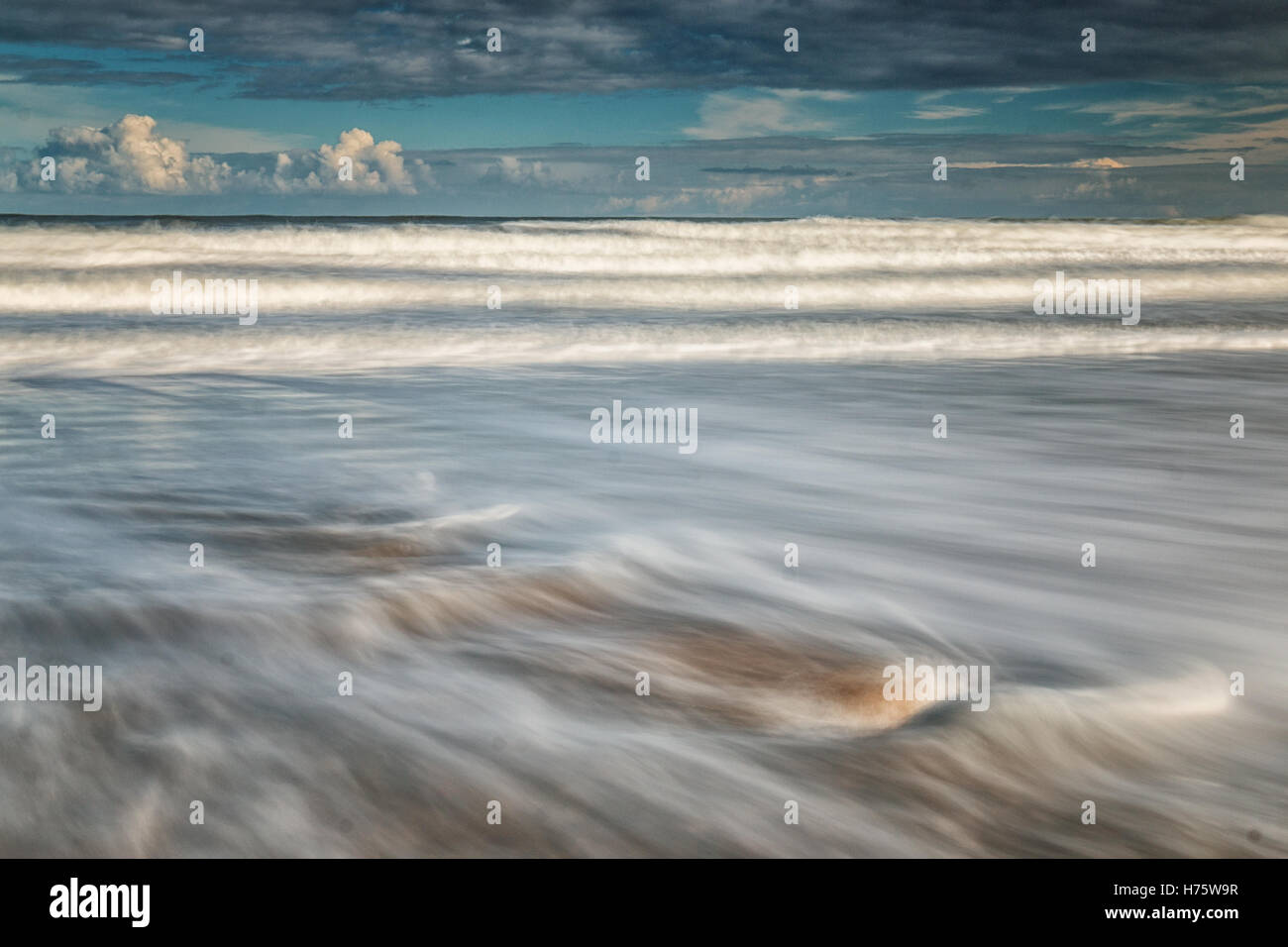 Long exposure capturing wave movement on a beach Stock Photo - Alamy