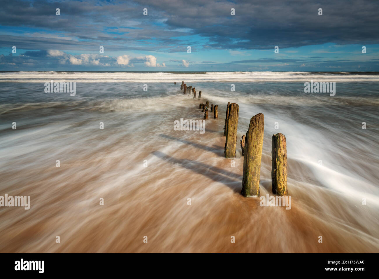 Long exposure capturing wave movement on a beach Stock Photo - Alamy