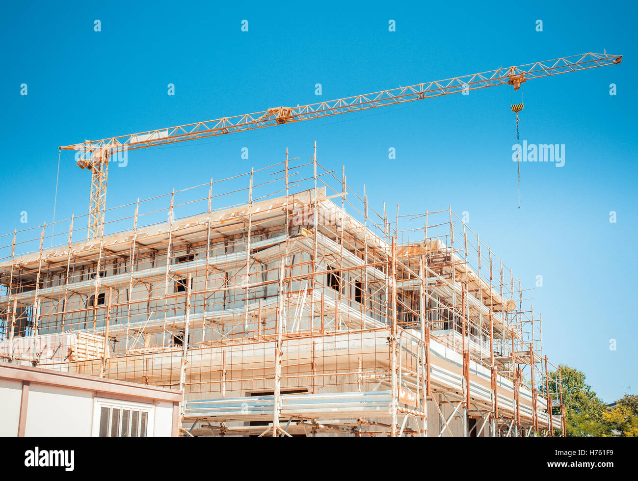 Building under construction with crane and scaffolding Stock Photo - Alamy