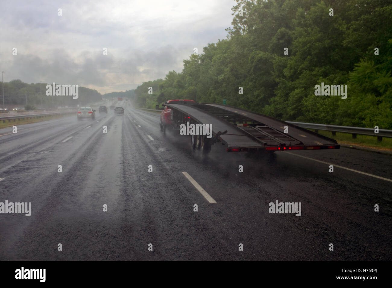 Trucking on highway during rain storm Stock Photo - Alamy