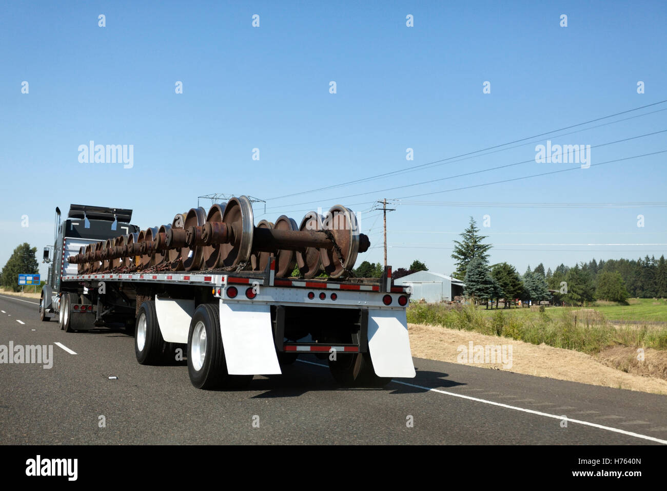 Rear view of railroad wheel freight on flatbed semi Stock Photo - Alamy