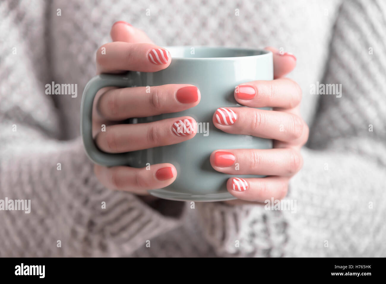 Women's hands holding a cup of drink Stock Photo - Alamy