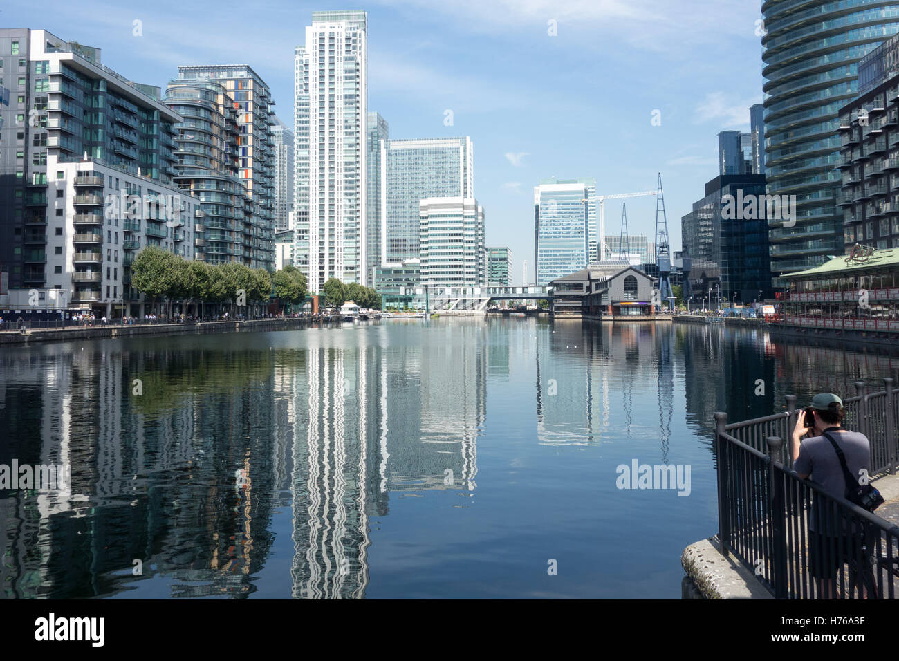 An unidentified man take photos of Millwall Inner Dock with South Quay ...