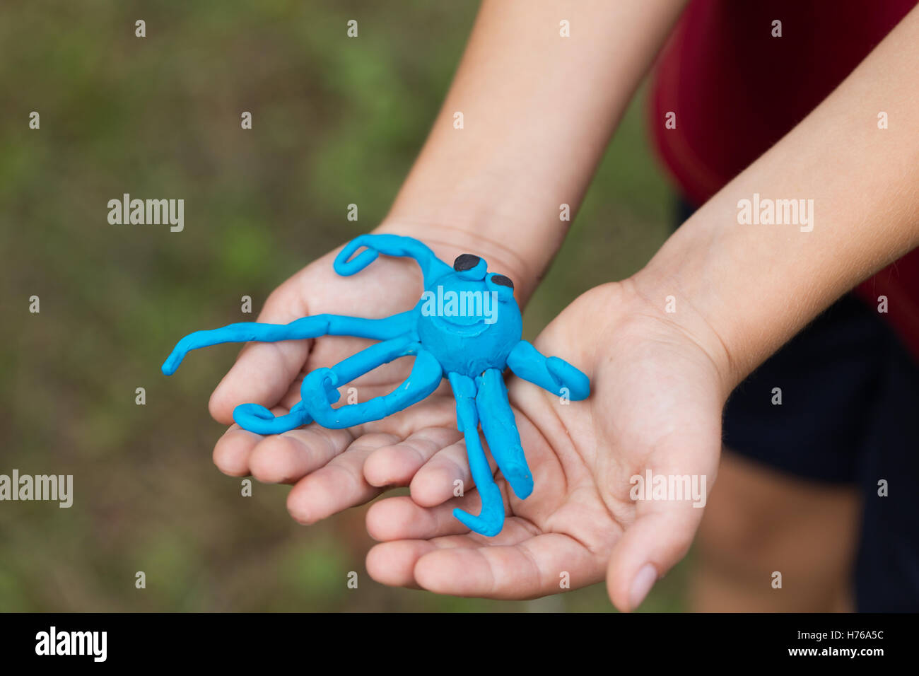 Boy holding a model clay octopus Stock Photo - Alamy