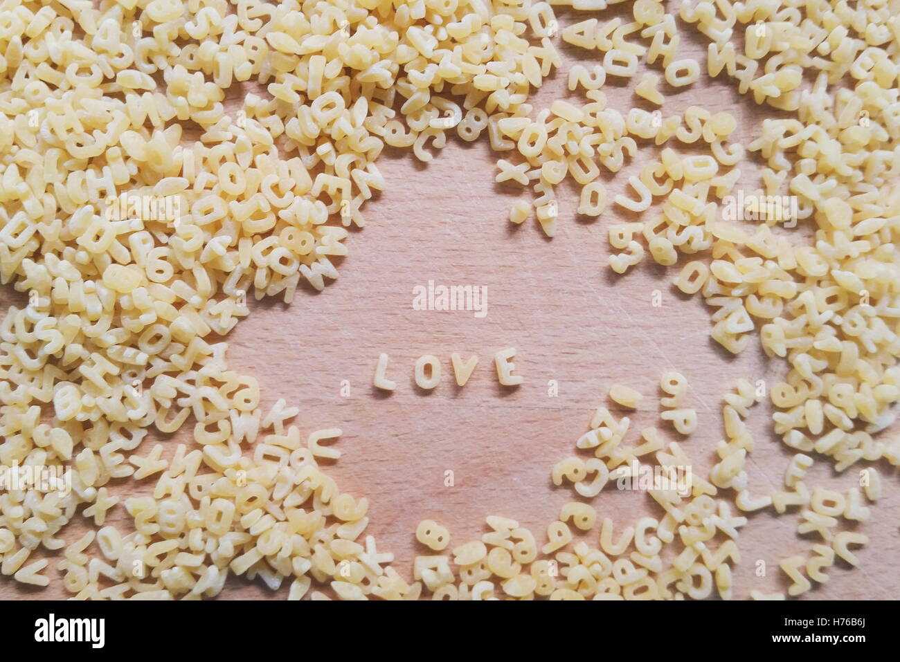 Pasta alphabet capital letters spelling the word love Stock Photo - Alamy