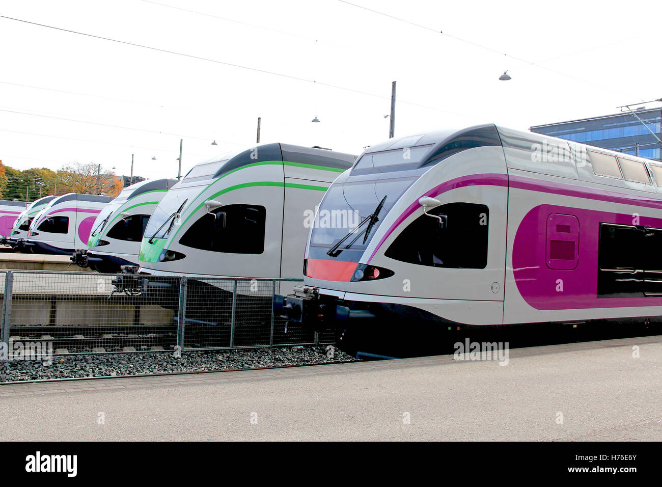 Five modern streamlined commuter trains at the railway station, detail ...