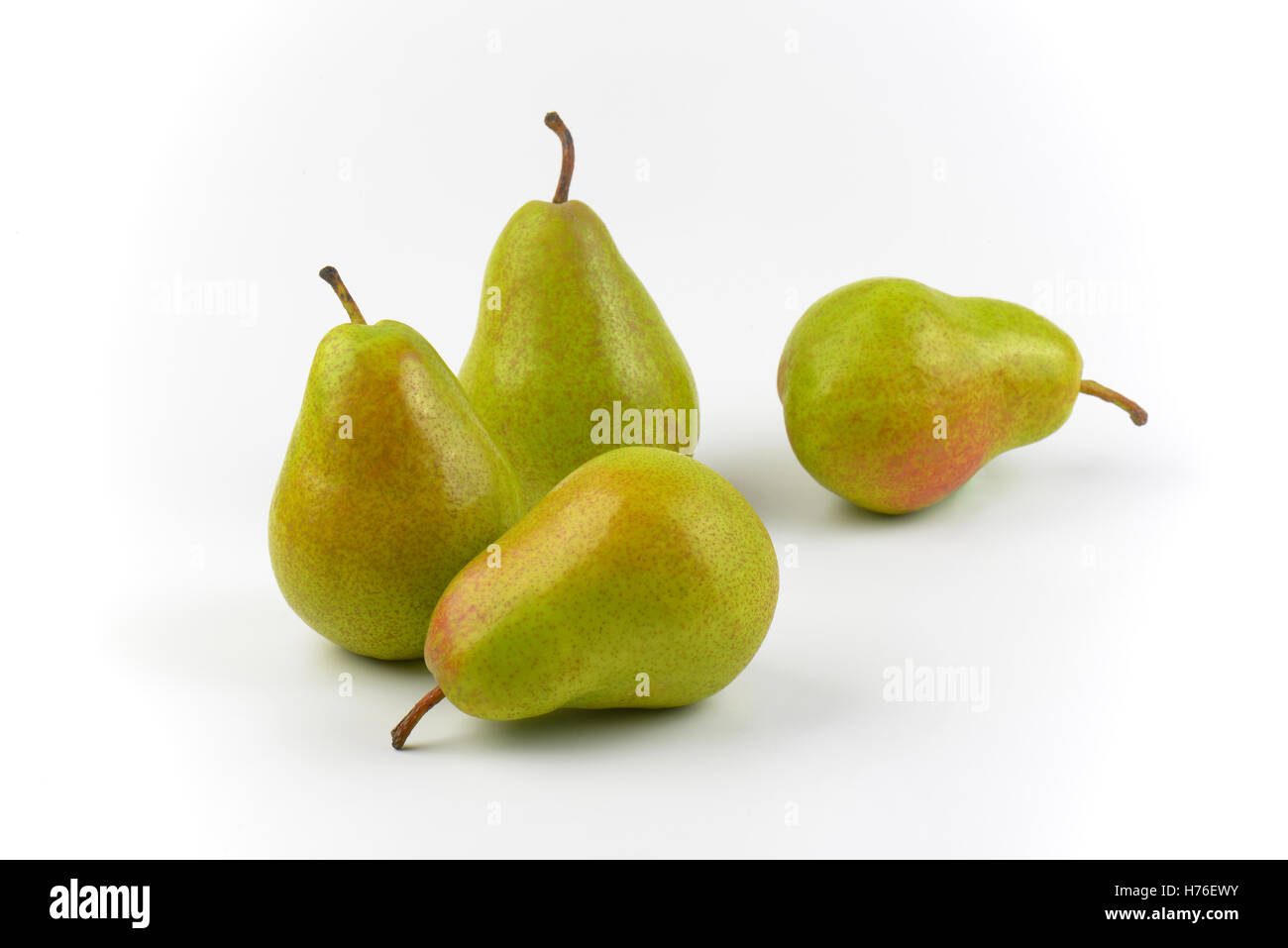 four ripe pears on white background Stock Photo - Alamy