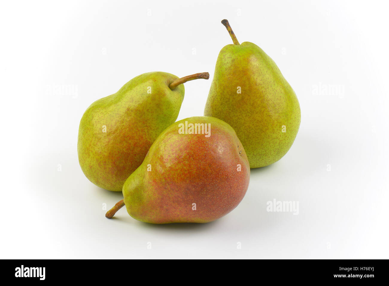 three ripe pears on white background Stock Photo - Alamy