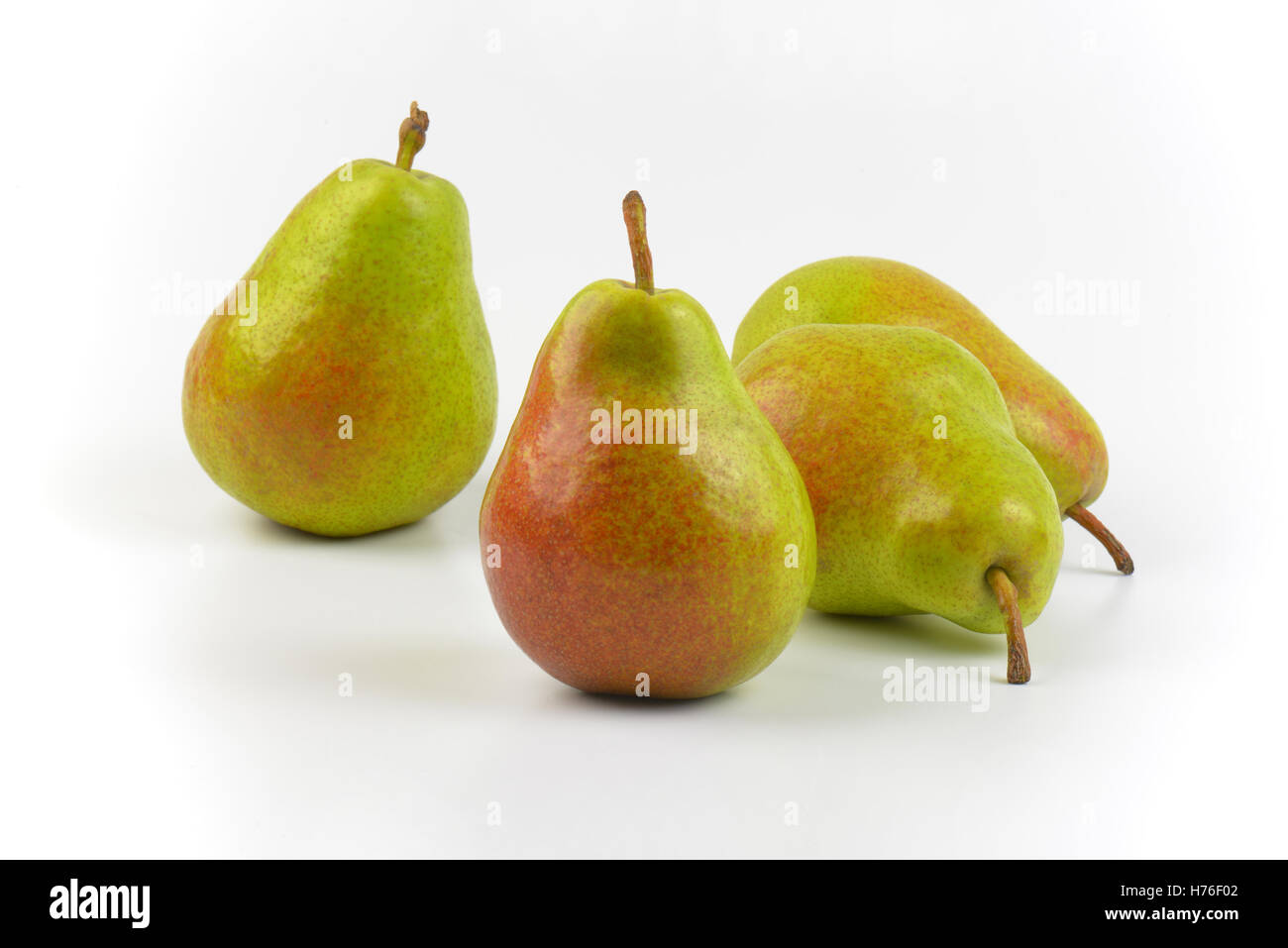 four ripe pears on white background Stock Photo - Alamy