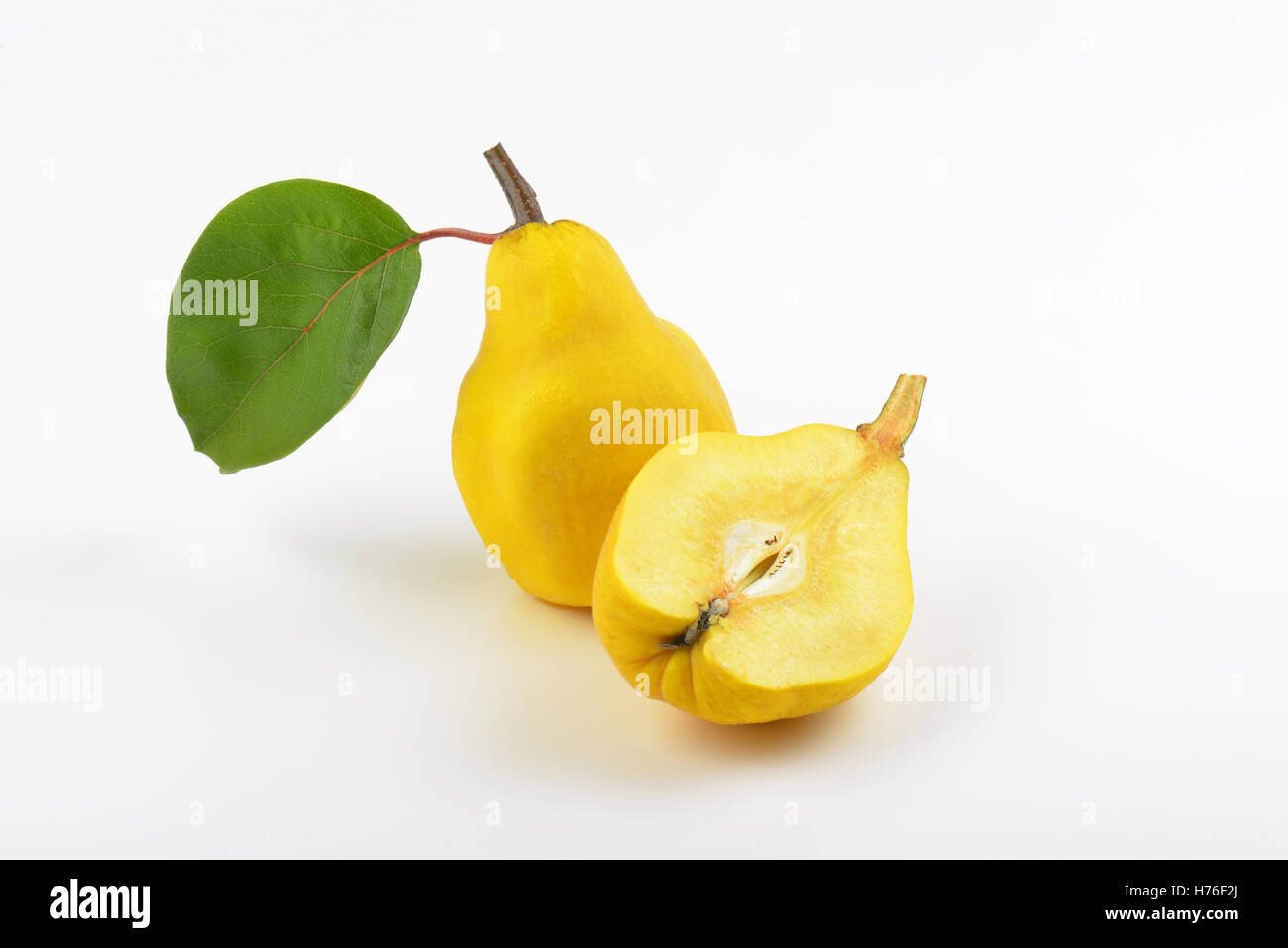 one and half yellow pears on white background Stock Photo - Alamy