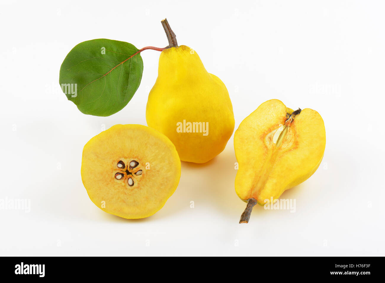 yellow pears on white background - one whole and two halves Stock Photo ...