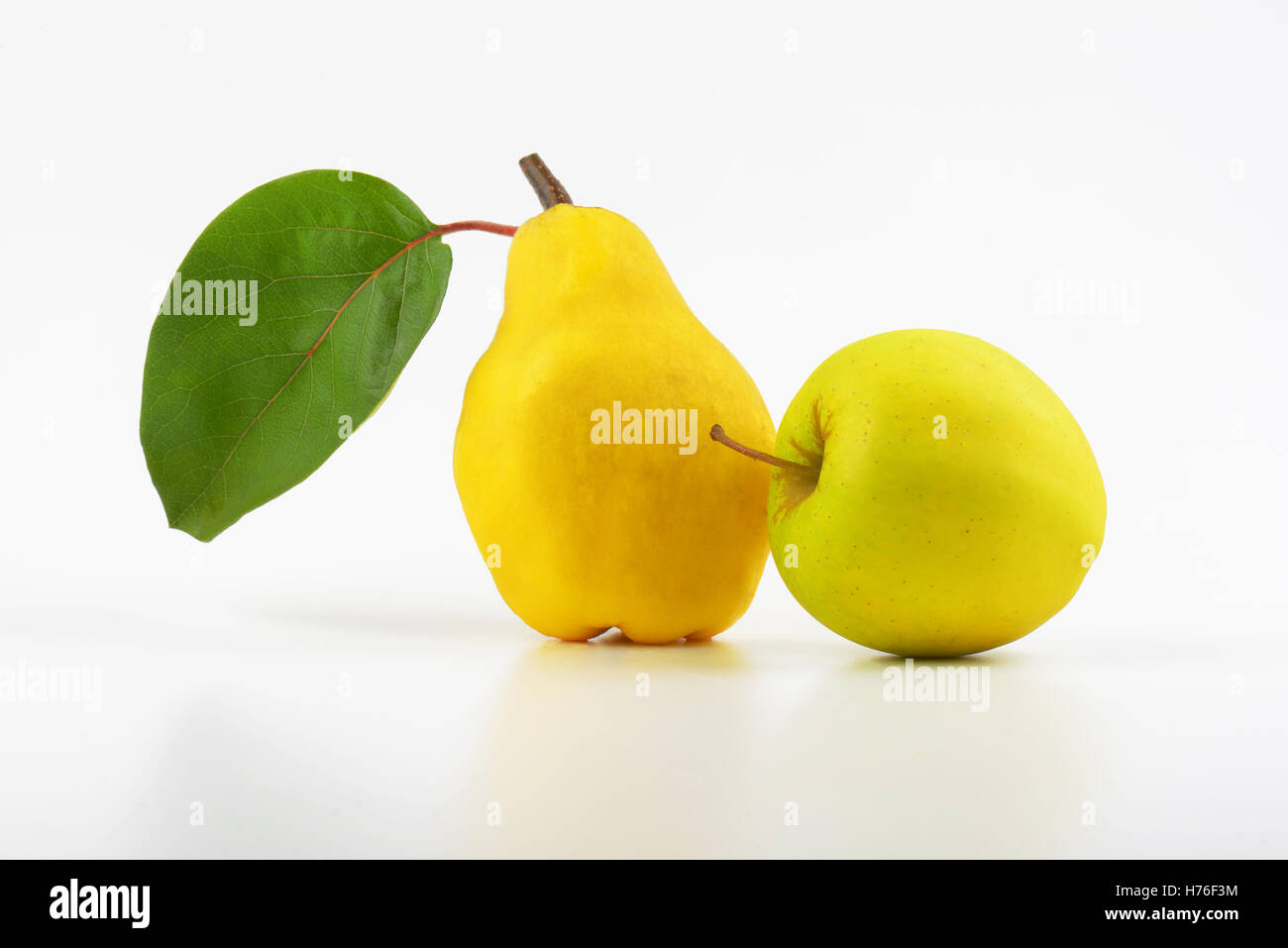 yellow pear and yellow apple on white background Stock Photo - Alamy