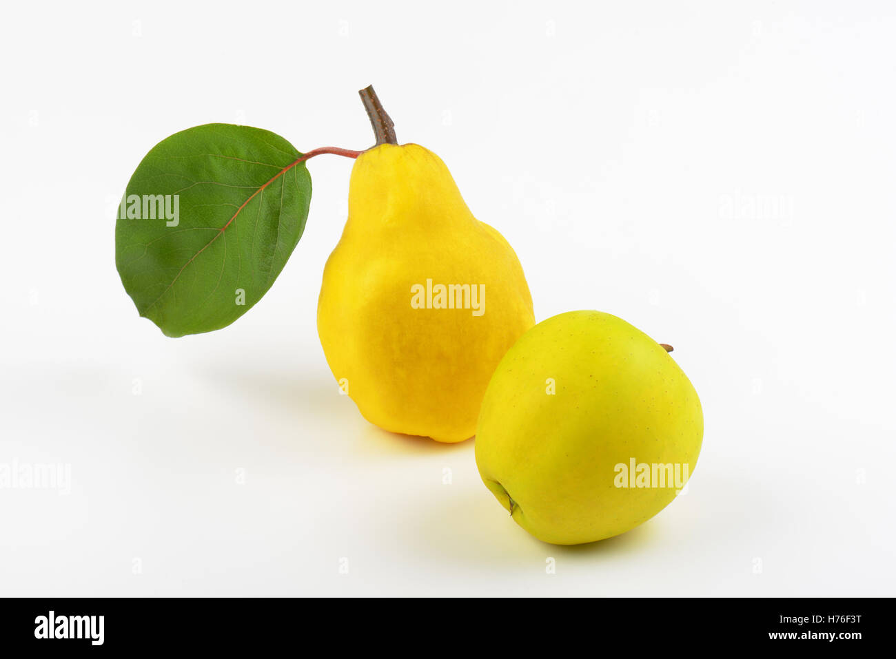 yellow pear and yellow apple on white background Stock Photo - Alamy