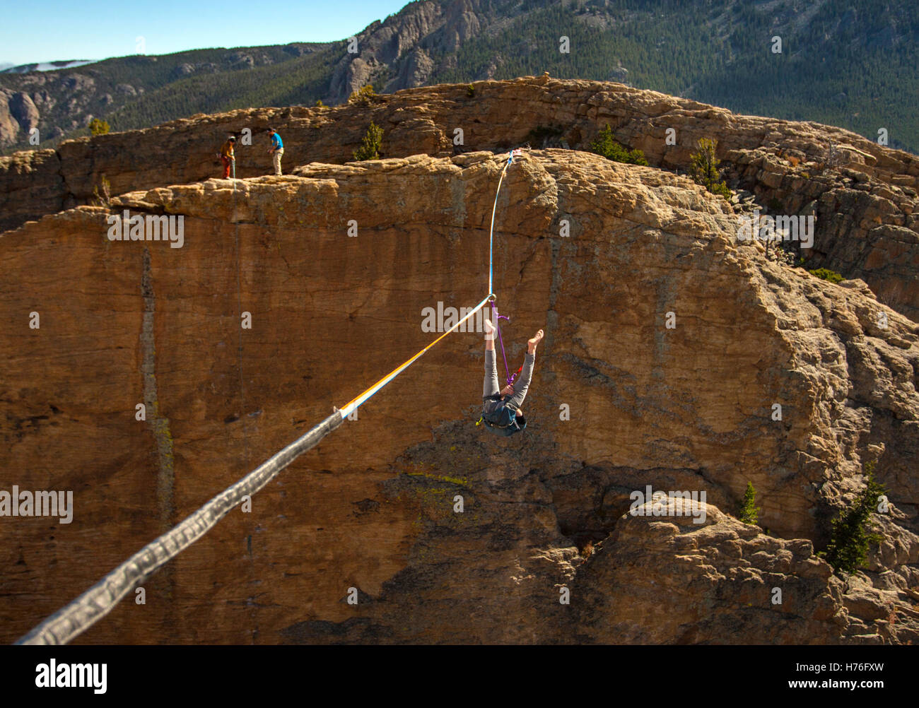Man falls off slackline in canyon Stock Photo - Alamy