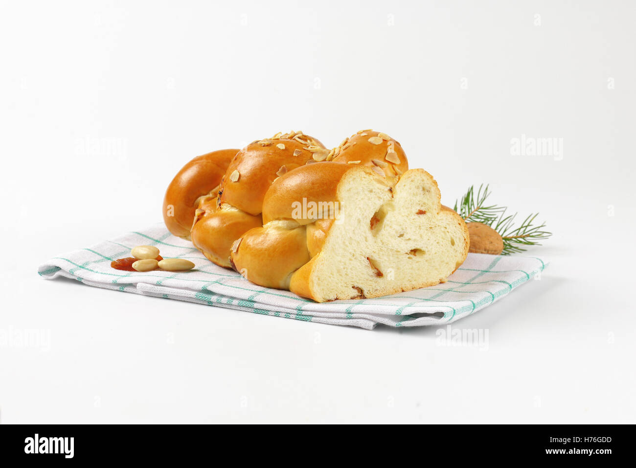 half of sweet braided bread on checkered dishtowel Stock Photo - Alamy