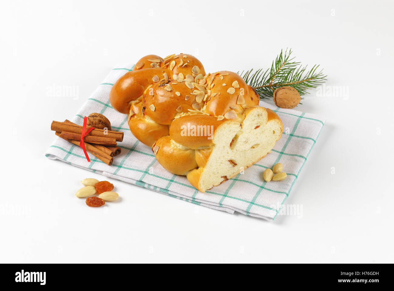 half of sweet braided bread on checkered dishtowel Stock Photo - Alamy