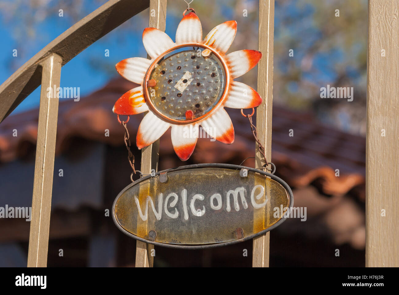 Colorful "welcome" sign from glass and metal on the gates of the house ...