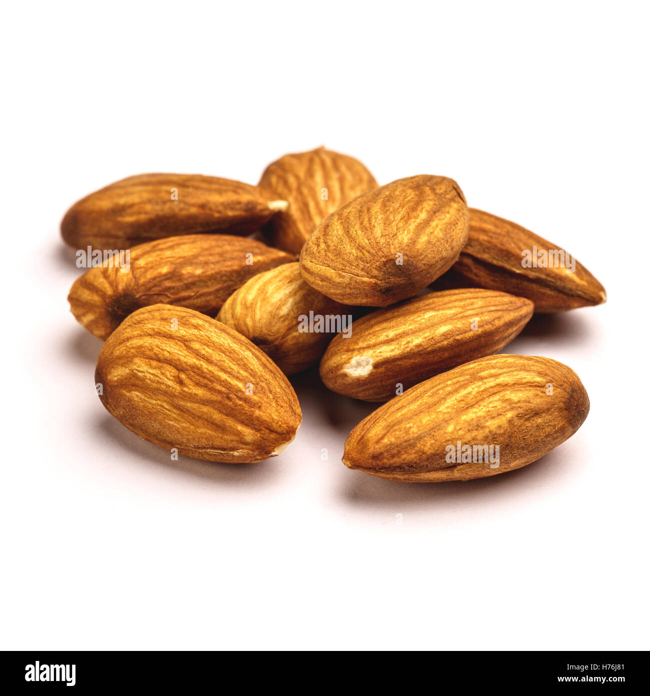 group of almonds isolated on white Stock Photo - Alamy