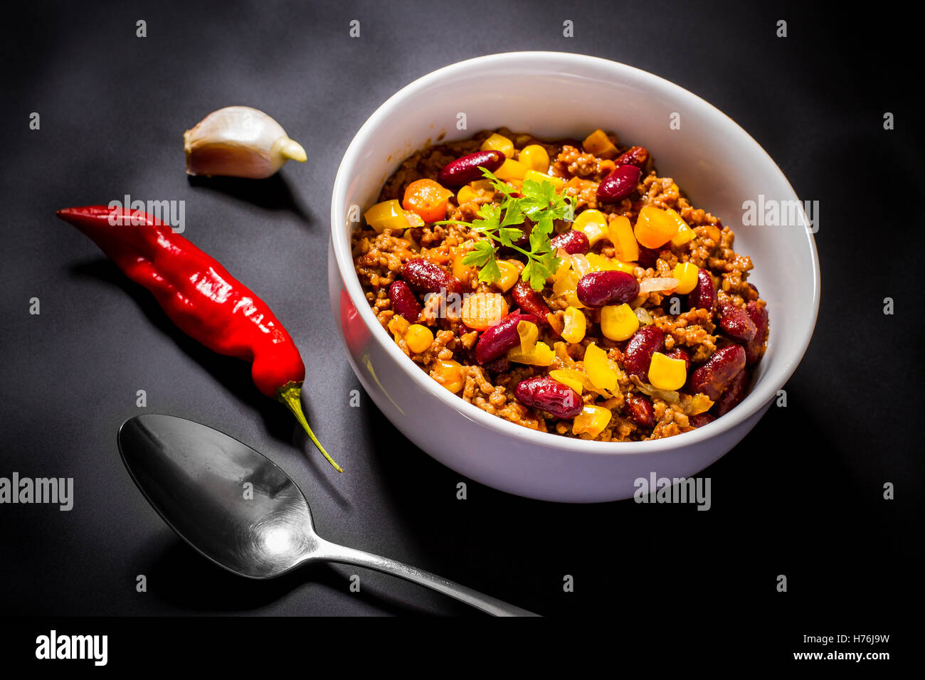 Chili con Carne on black, top view Stock Photo - Alamy
